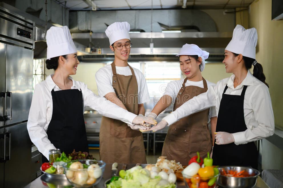 Group of Cooking School Students Joining Hands in Teamwork Gesture ...