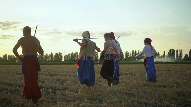 Group of Cossack Men in Traditional Clothes Swinging and Spinning Sharp ...