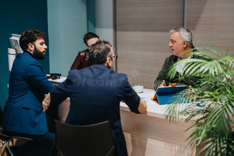 Business Professionals Having a Team Discussion in a Modern Office ...