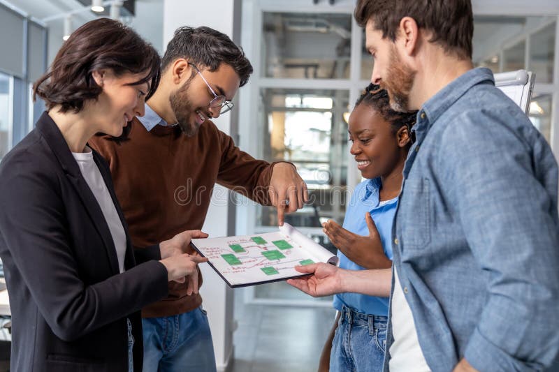 Group of Coworkers Considering Business Ideas in Office Stock Image ...