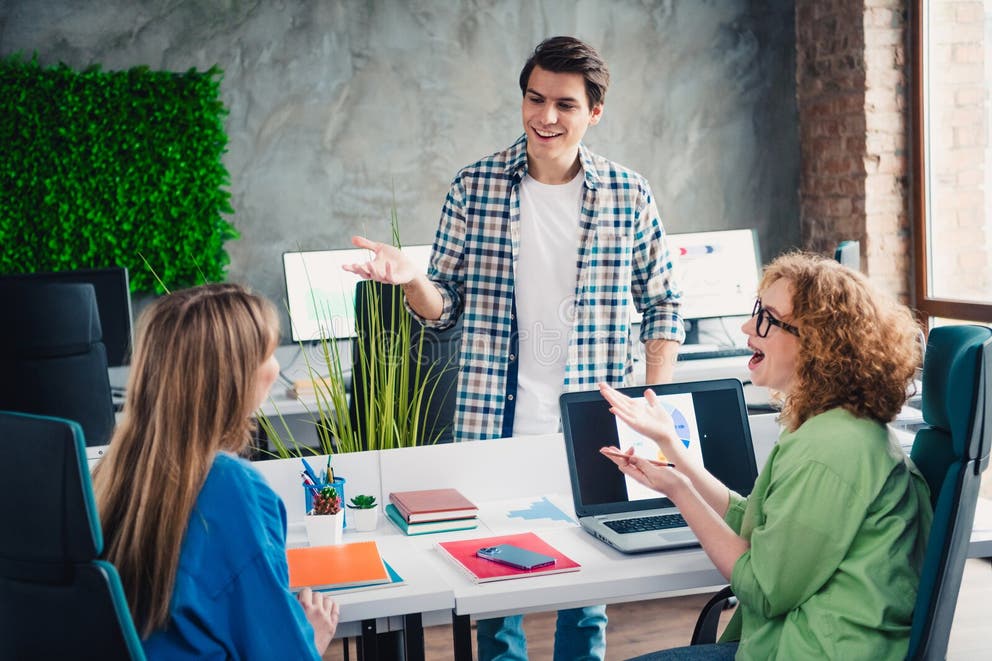 Coworkers Collaborating in a Casual Office Environment with Shared ...