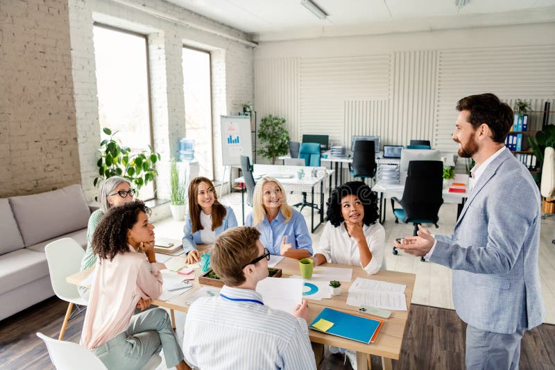 Diverse Professionals Collaborate in a Modern Office Space during a ...