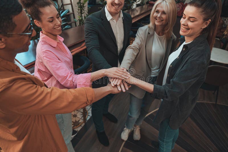 Group of Coworkers Stacking Hands Together One by One in Unity. Support ...