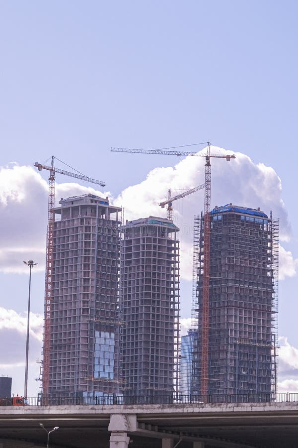 A Group of Cranes are Working on a Building Under Construction Stock ...