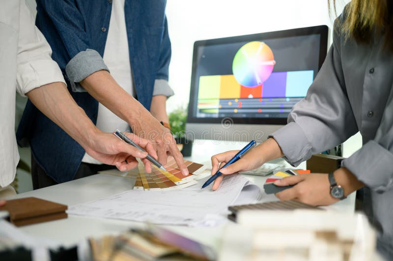 Group of Creative People Choosing Paint Color and Discussing Interior ...