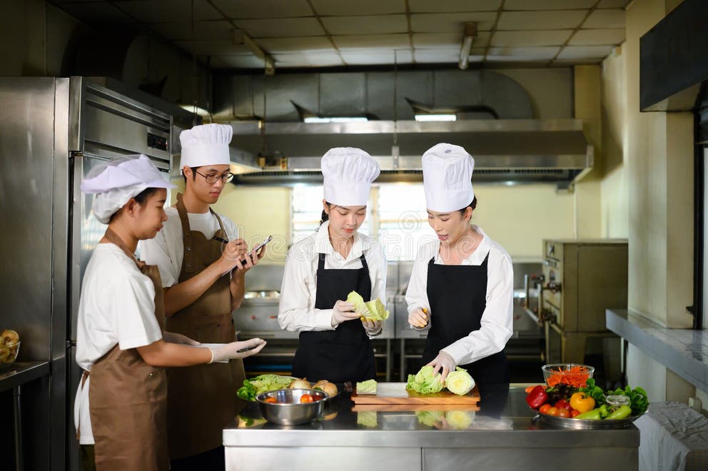 Group of Culinary Students in Chef Hats Learning Food Preparation ...