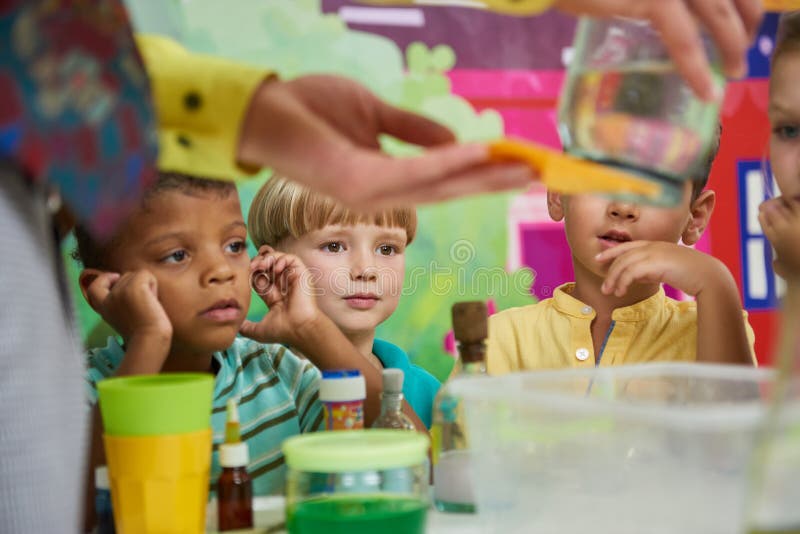 Group of Curious Kids Watching Chemistry Experiment in Playroom. Stock ...
