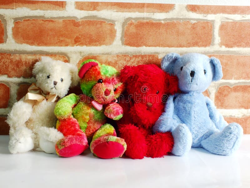 A Group of Cute Teddy Bears Sitting Together Against with Wallpaper ...