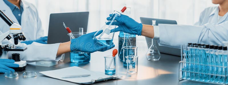 Group of Dedicated Scientist Conduct Chemical Experiments in Lab ...
