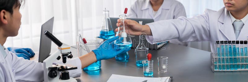 Group of Dedicated Scientist Conduct Chemical Experiments in Lab ...
