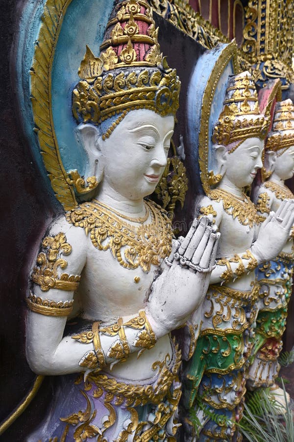 Deity Statues Standing in a Row on a Temple Wall in Thailand Stock ...