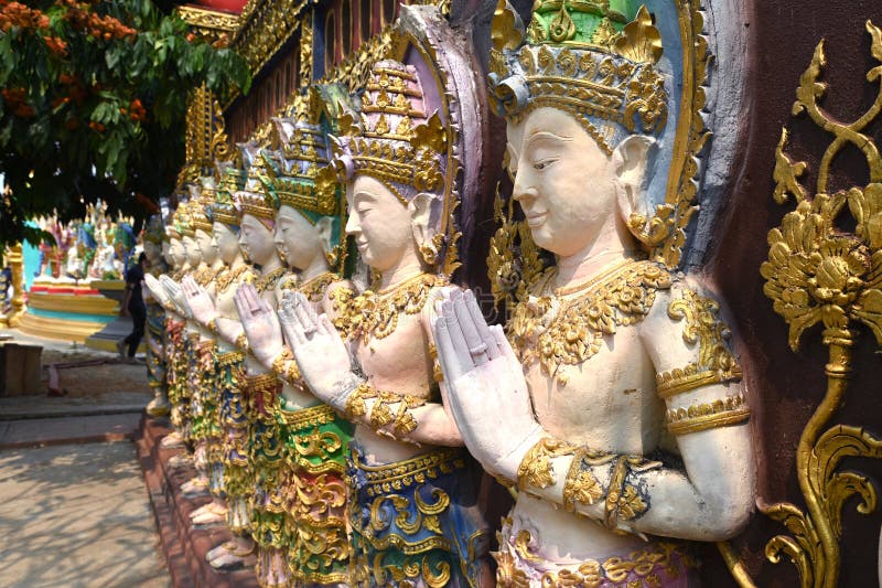 Deity Statues Standing in a Row on a Temple Wall in Thailand Stock ...