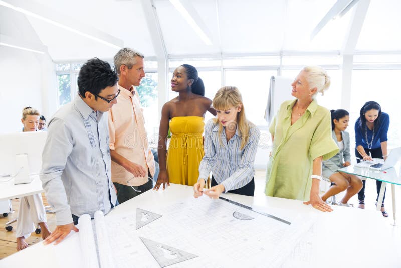 Female Boss Leading Meeting of Architects Sitting at Table Stock Photo ...