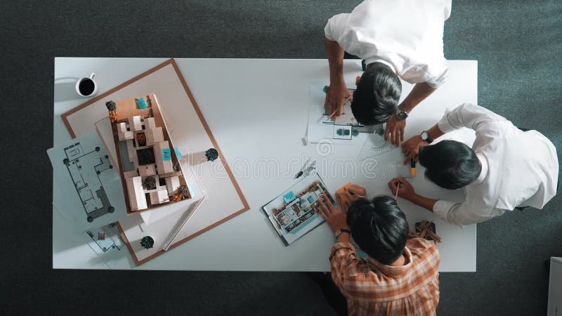 Group of Designer Look at Model while Discussing about Building ...