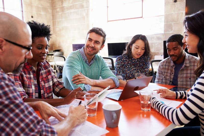 Group of Designers Having Meeting Around Table in Office Stock Photo ...