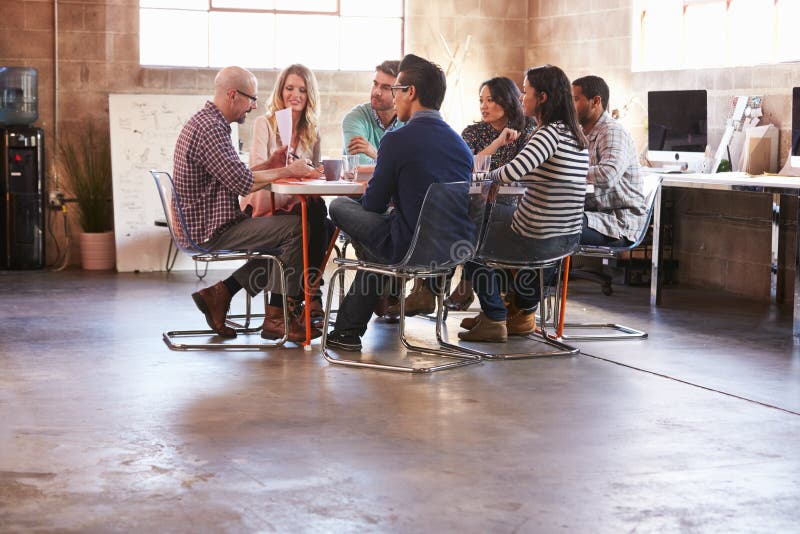 Group of Designers Having Meeting Around Table in Office Stock Photo ...