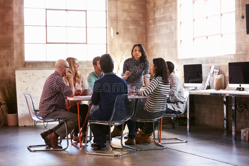 Group of Designers Having Meeting Around Table in Office Stock Image ...