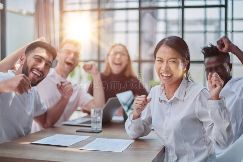 Group of Different Business People Celebrating Victory while Sitting at ...