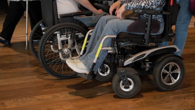 A Group of Disabled People in Modern Wheelchairs Stand in the Hospital ...