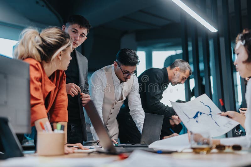 A Group of Diverse Business People Gathers Around a Table ...