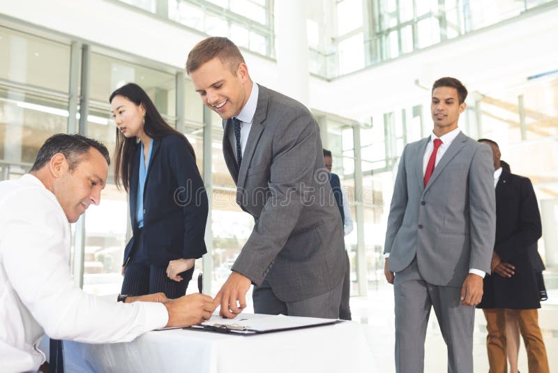 Group of Diverse Business People Waiting in Line for Registering Stock ...