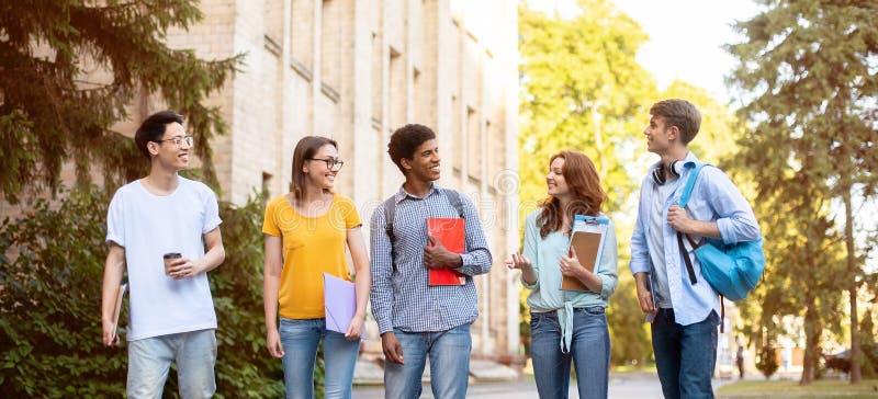 Group of Diverse Coursemates Talking about University Study Walking ...