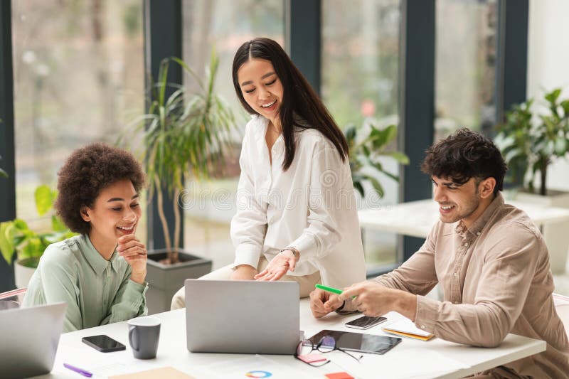 Group of Diverse Coworkers Using Laptop Discussing Project in Office ...