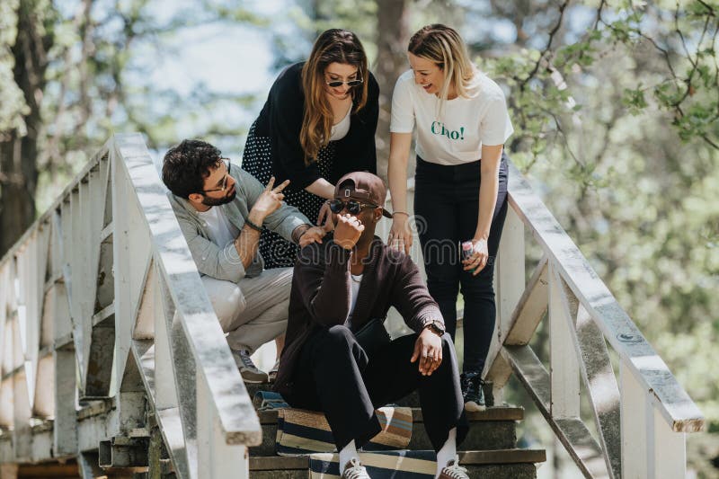 Group of Diverse Friends Enjoying a Fun Conversation on Park Steps on a ...