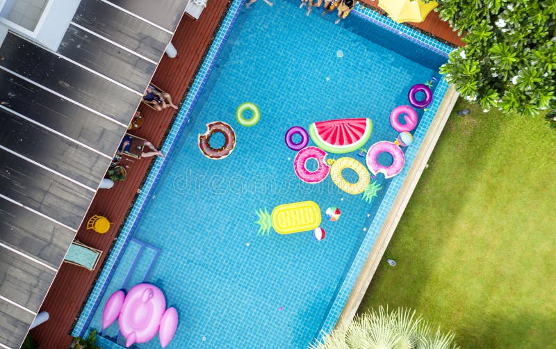 Group of Diverse Friends Enjoying the Pool with Inflatable Tubes Stock ...