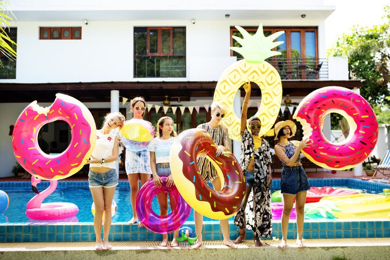 Group of Diverse Friends Holding Inflatable Tubes by the Pool Stock ...