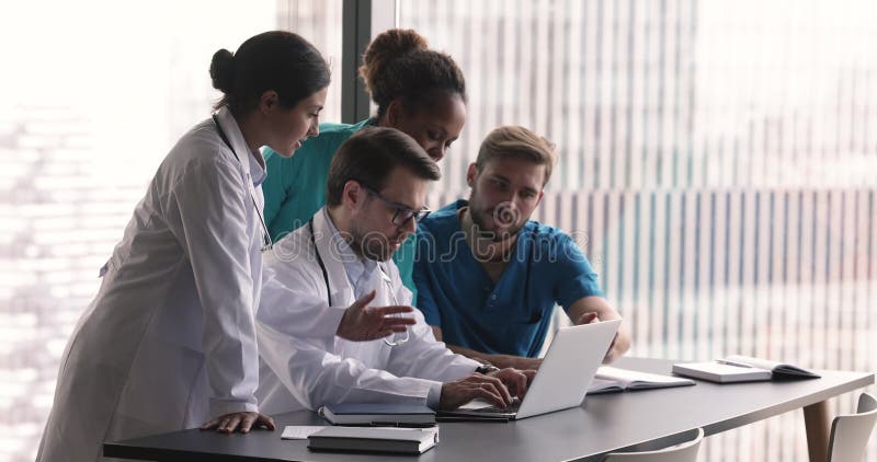 Group of Diverse General Practitioners Engaged in Teamwork Using ...