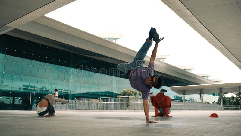 Group of Diverse Hipster or Dancer Doing Head Spin in Front of Mall ...