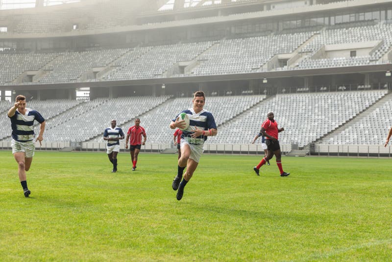 Group of Diverse Male Rugby Players Playing Rugby in Stadium Stock ...