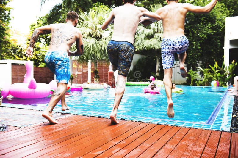 A Diverse Group of Friends Enjoying Summer Time by the Pool Stock Photo ...