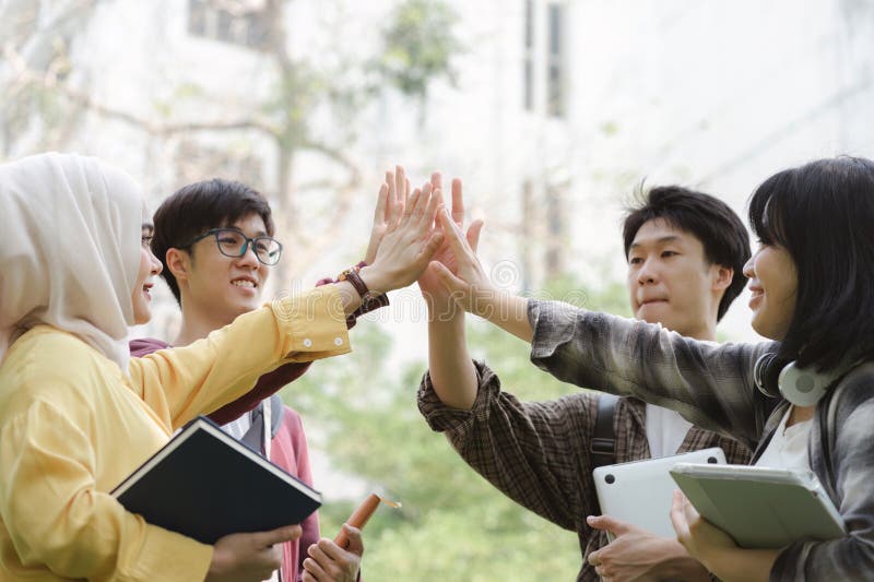 A Group of Diverse, Multiracial Young People are Shown Happily Stacking ...