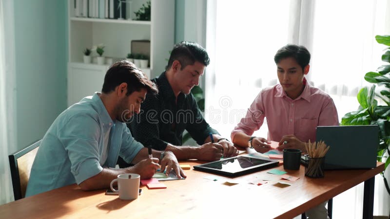 Group of Diverse People Sharing Idea while Writing at Sticky Notes ...