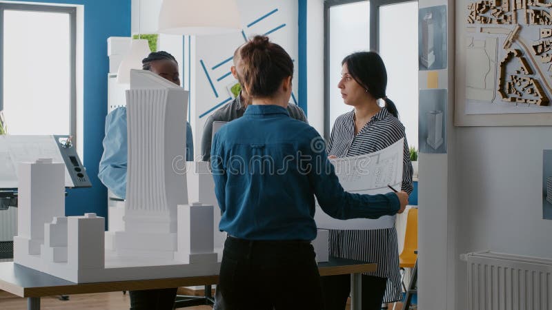 Group of Diverse People Working on Design of Building Model with Laptop ...