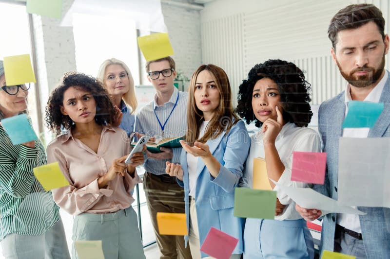 Diverse Office Team Collaborating on Ideas Using Sticky Notes in a ...