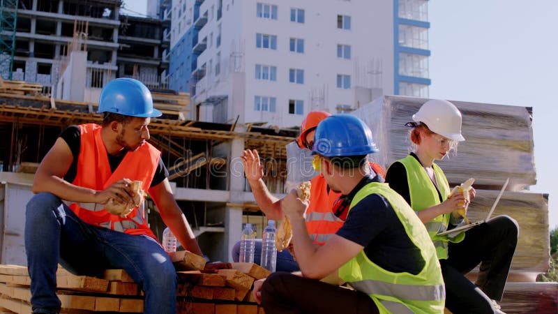 Diverse Group of Construction Workers Collaborate on a Construction ...
