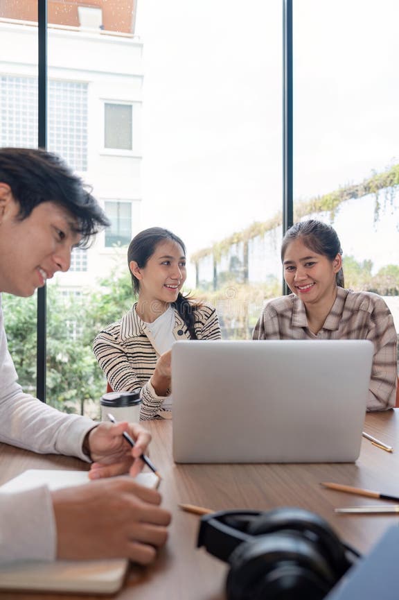 Group of Diverse Student Collaboration on a Project with a Laptop in a ...