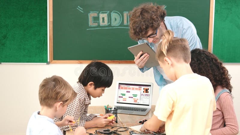 Group of Diverse Student Working Together while Teacher Hold Tablet ...