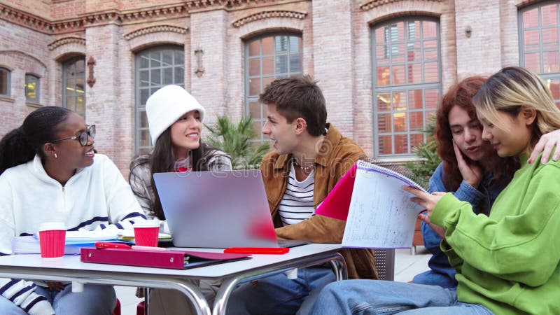 Group of Diverse Students Collaborating on a Laptop in an Outdoor Study ...