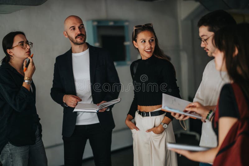 Students Engaging with Professor in University Hallway Discussion Stock ...