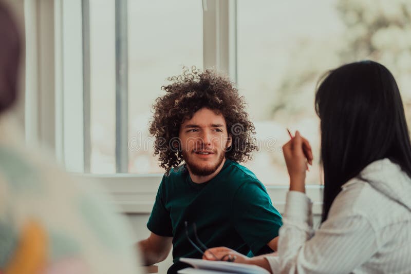 A Group of Diverse Students Engages in Lively Discussion As they ...