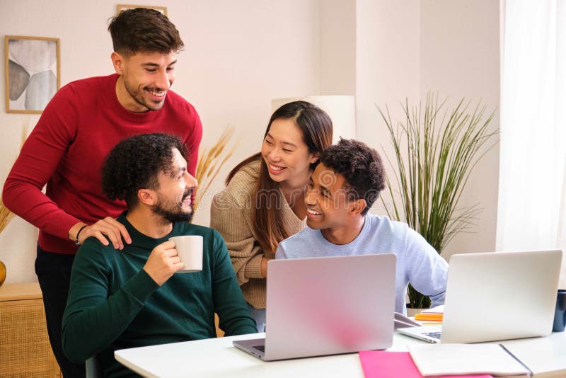 Group of Diverse University Colleagues Laughing and Studying Together ...