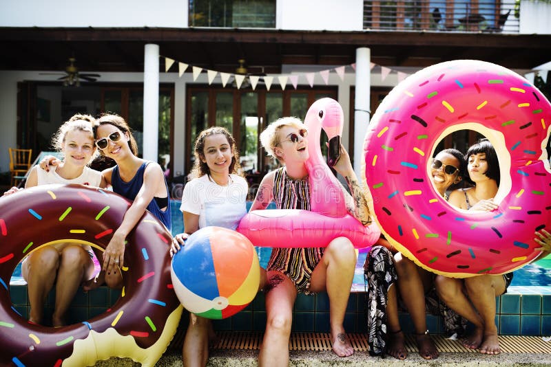 Group of Diverse Women Sitting by the Pool with Inflatable Tubes Stock ...