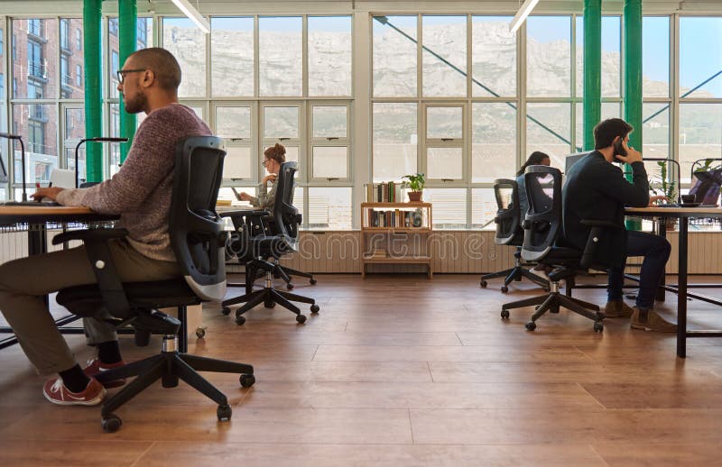 Group of Diverse Young Businesspeople Working at Their Desk in an ...