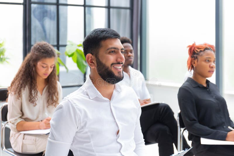 Group of Diverse Young People Sitting in a Conference Room. Stock Image ...