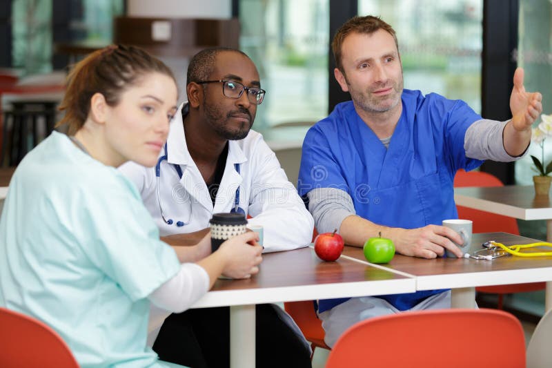 Group Doctors in Cafeteria Eating Relaxing Talk Stock Image - Image of ...