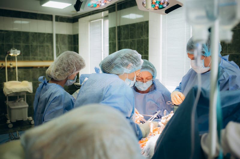 Surgical Team Performing Surgery in Modern Operation Theater,Team of ...